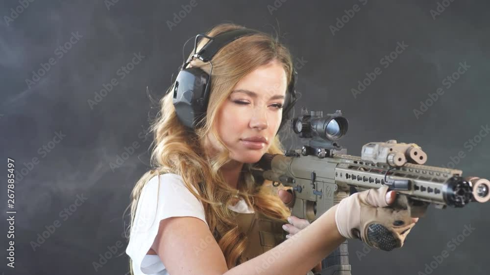 Airsoft female shooter playing strikeball, sets her sights on enemy ...