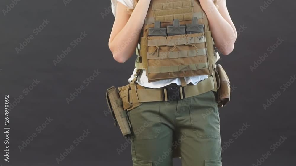 Brave amazing army girl wearing military plate carrier upon white t ...