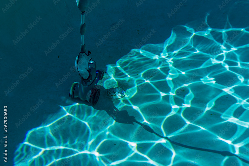 floating automated underwater pool cleaner. Stock Photo | Adobe Stock
