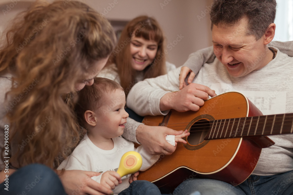Portrait of a large family, children and parents sing and play the ...