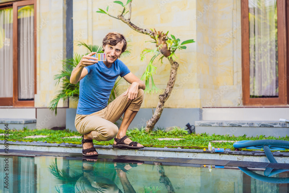 Pool worker checks the pool for safety. Measurement of chlorine and PH ...