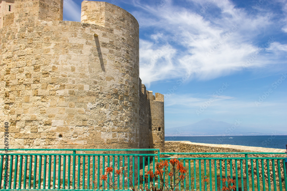 Brucoli castle detail of side tower with mount Etna far in the sea ...