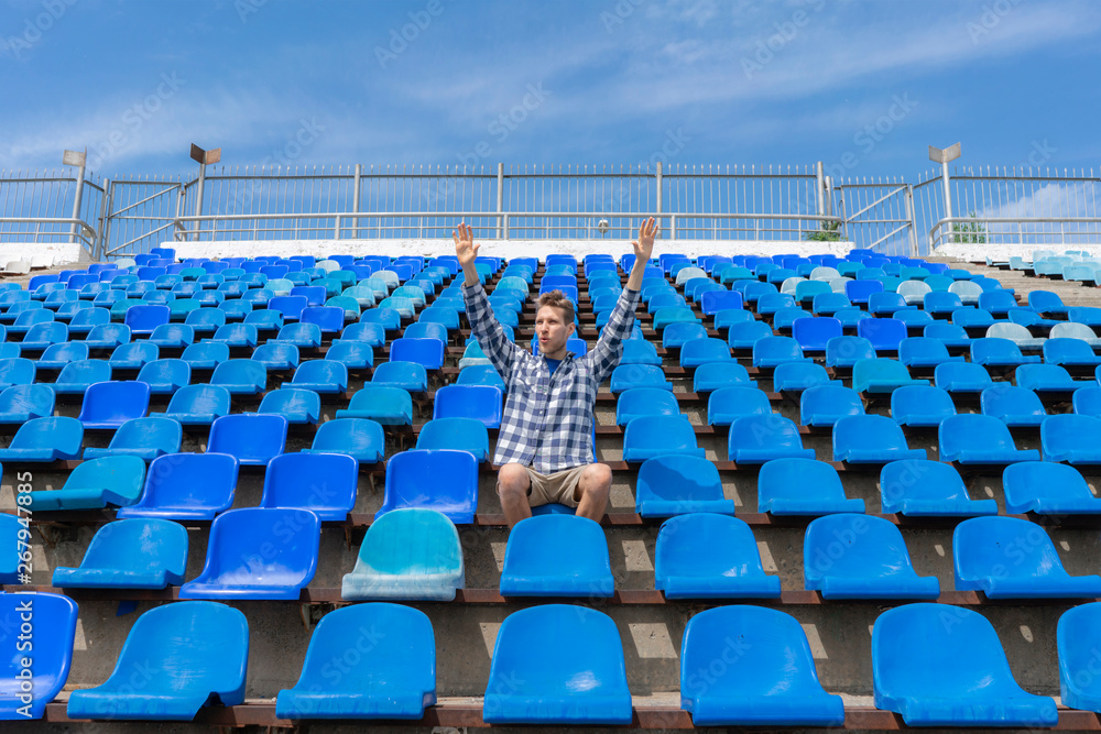 lonely man on the empty stadium seat cheering for the team, one man ...