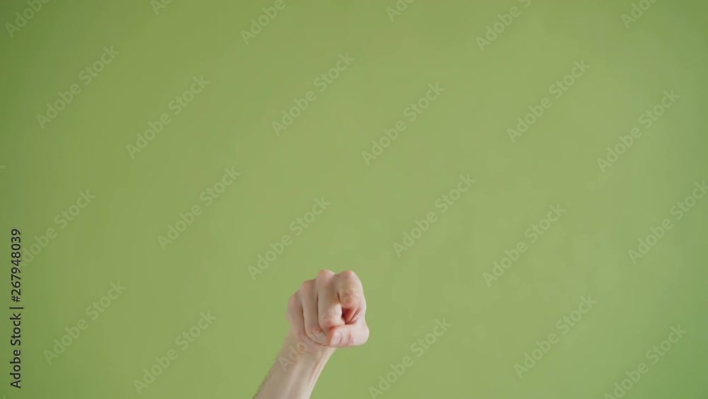 Close-up shot of male hand pointing at camera and making come here ...