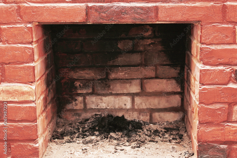 Red brick dirty fireplace with remains of ash after wooden firewood ...