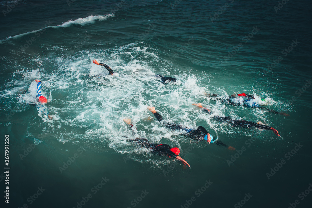 Swimmers swim during Swimming Competition in the Sea. Open water sport ...
