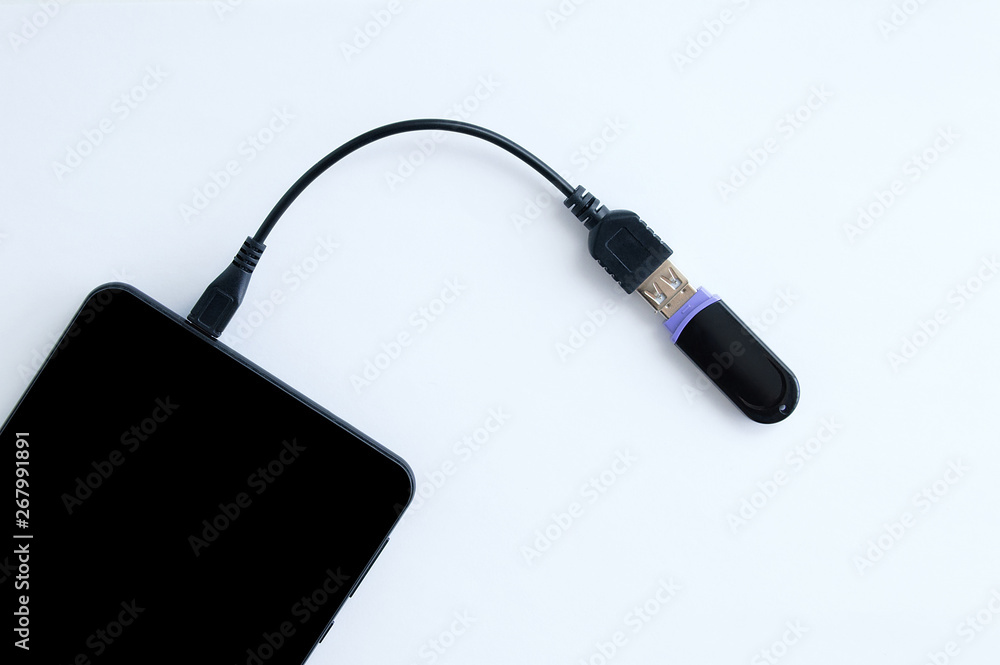 Transfer digital data. The cable is connected to the smartphone and USB ...