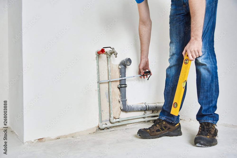 Plumbing in the house. Installation of sewer pipes in the kitchen of an ...