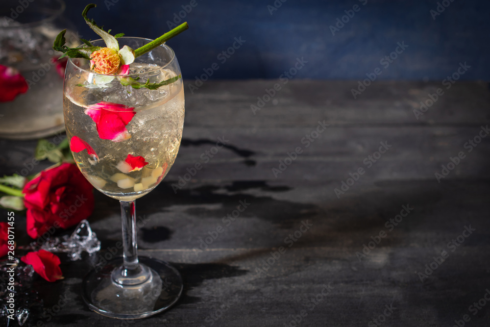 Sparkling cold water detox with rose and ice on the wood table there ...