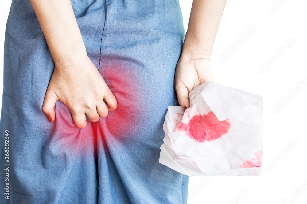 woman hand holding her painful butt and used bloody toilet paper caused ...