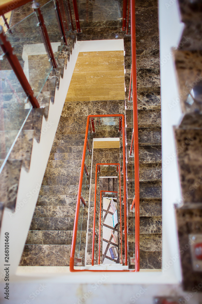 The top view on multystoried ladder flight. A modern marble ladder in ...