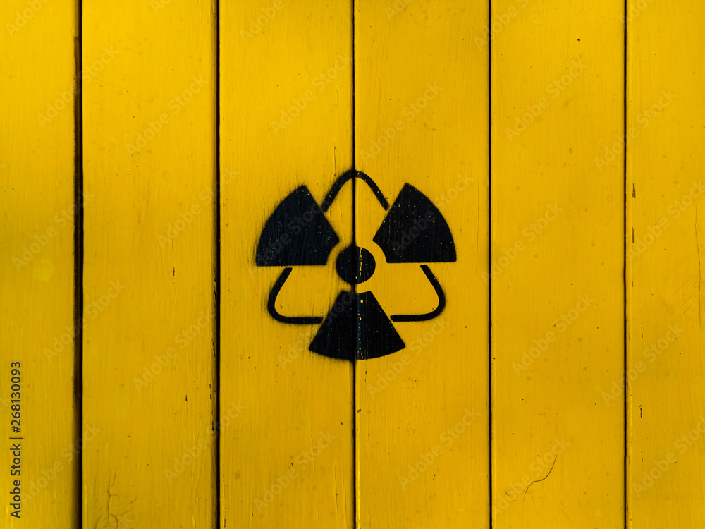 Sign of radiation on a yellow wooden board. Radioactive sign - symbol ...
