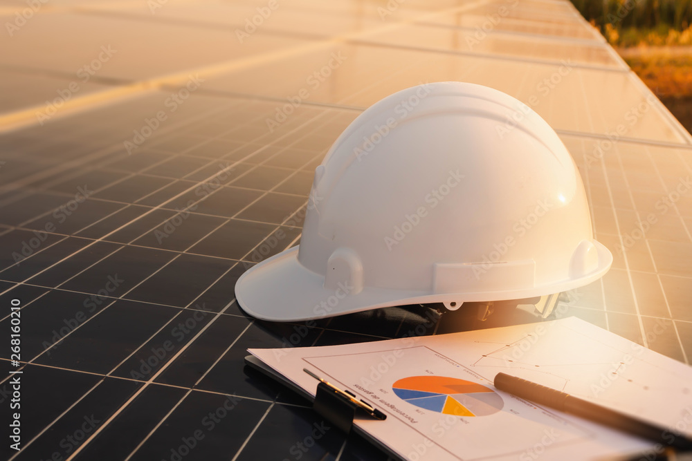 Engineers are examining the performance graph of energy production from ...