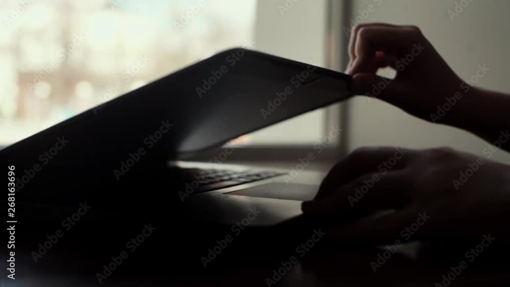 Woman hands turns off laptop and closes laptop lid of a laptop close-up ...