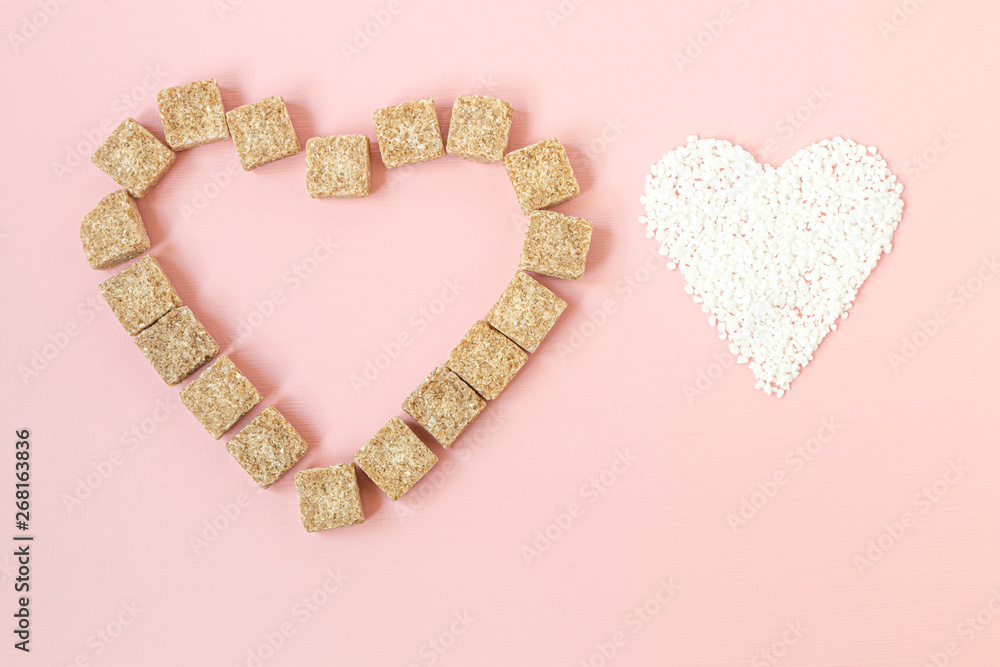 Brown sugar cubes and granulated white sugar in heart shapes Stock ...
