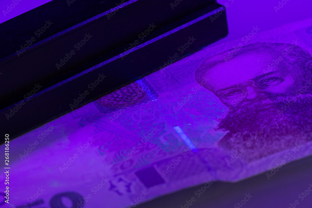Verifying the authenticity of the fifty hryvnia banknote in ultraviolet ...