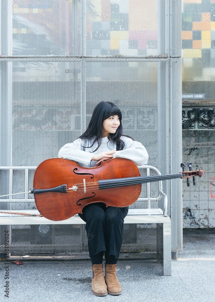 Portraits of female jazz cellist playing in outdoor space Stock Photo ...