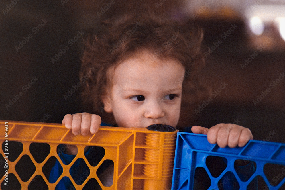 Toddler plotting his escape from behind a baby gate Stock Photo | Adobe ...