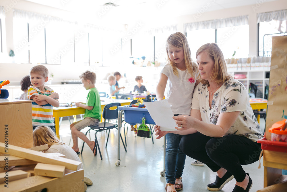 Teacher interacting with students in classroom Stock Photo | Adobe Stock