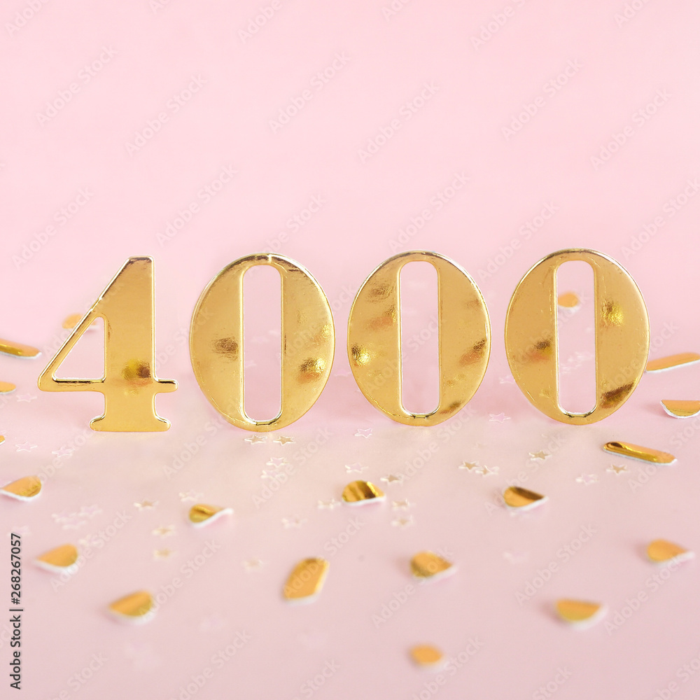 The number 4000 in golden numbers on a pink background and golden ...