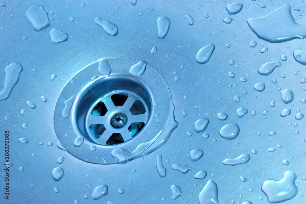 Water drain in the sink, plumbing device. In the home, water is drained ...