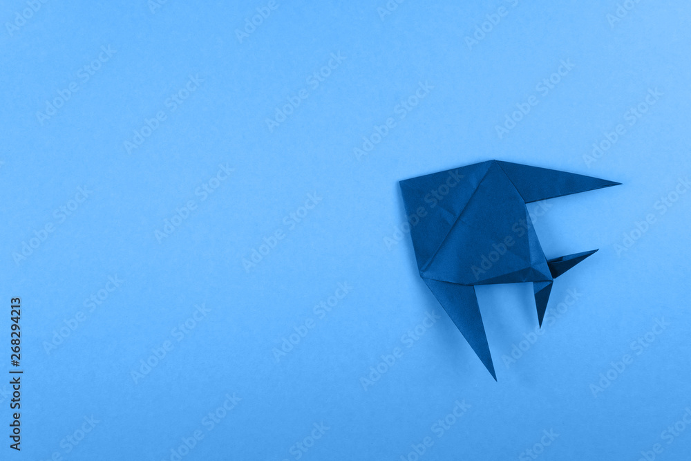 Origami tropical fish on sky blue minimalistic background. Paper sea ...