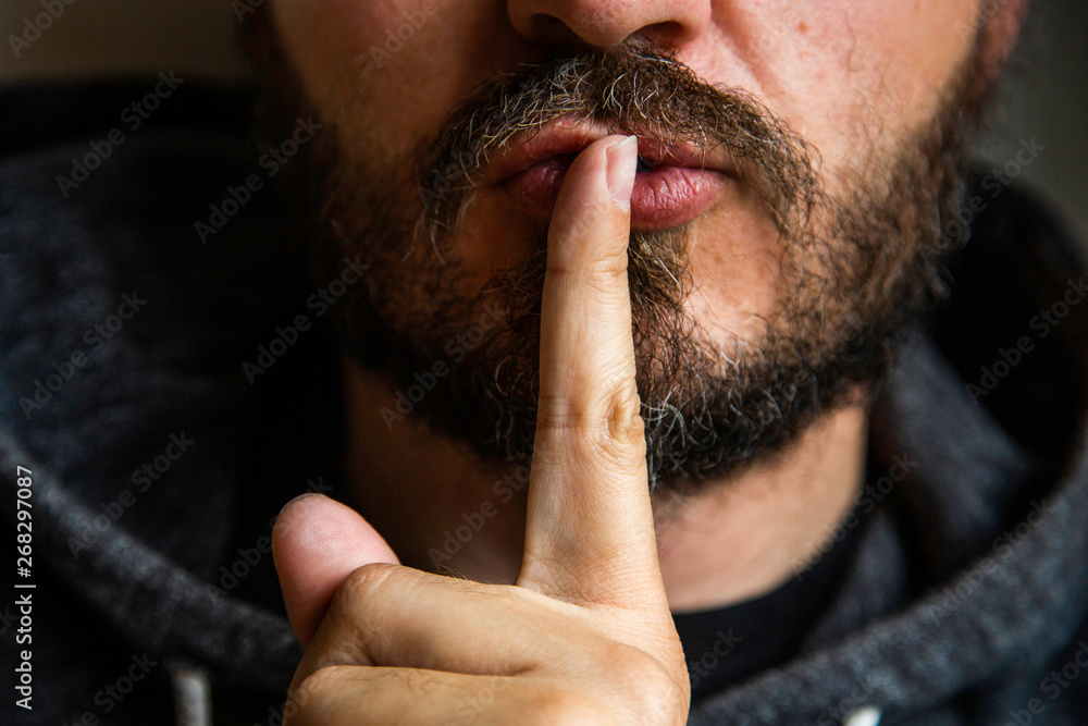 Don't speak, be quiet - close up portrait of bearded man on the door ...