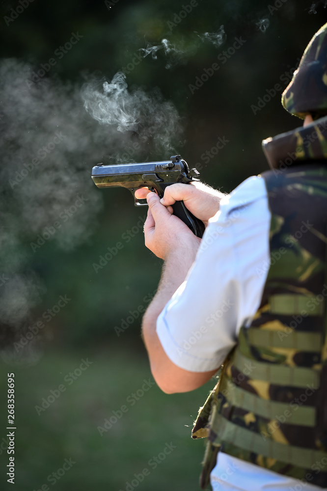 Outdoor target shooting with a 9mm pistol in a shooting range Stock ...