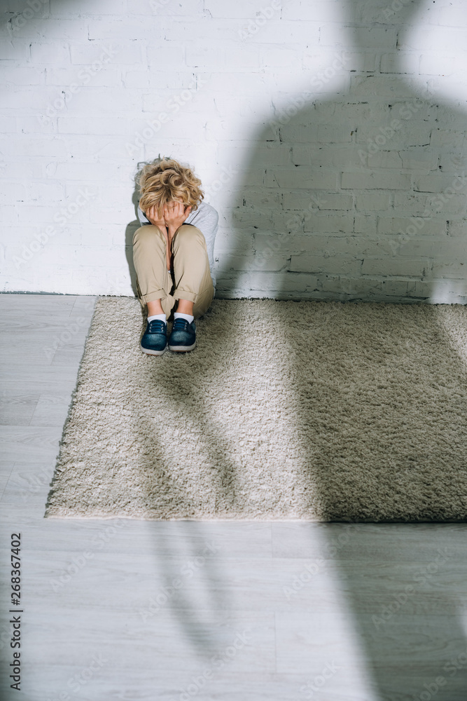 silhouette and scared little boy sitting on carpet Stock Photo | Adobe ...