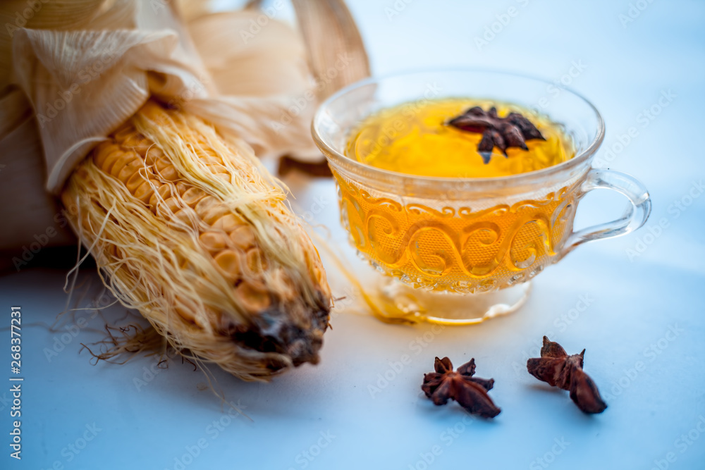 Beneficial detoxifying corn tea in a glass cup isolated on white along ...