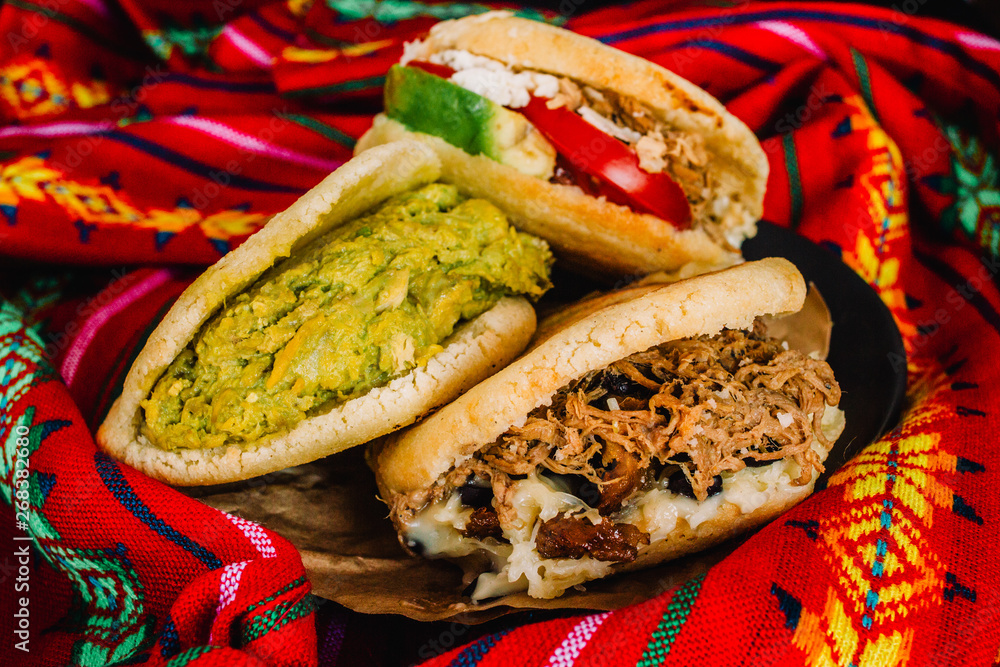 Venezuelan arepas on a colorful background, made with maize and filled ...