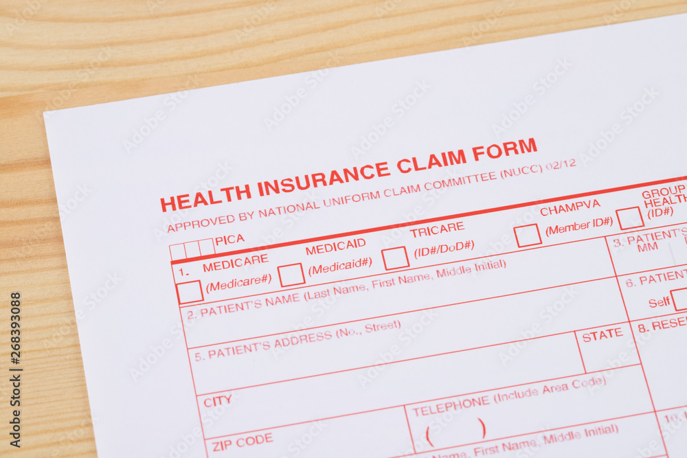Health insurance claim form on wooden desk Stock Photo | Adobe Stock