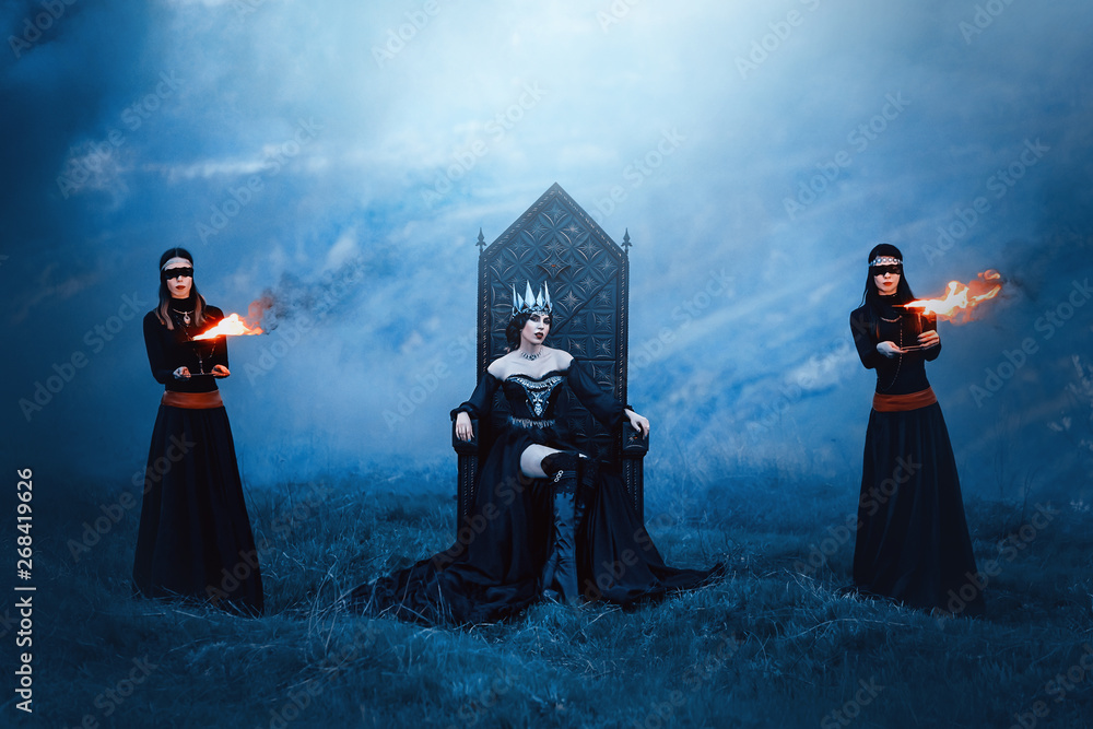 majestic priestess in long black dress with bare shoulders, witch raven ...