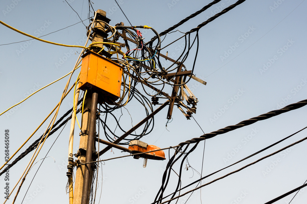 Tangled messy electrical wires on pole posing a safety hazard Stock ...