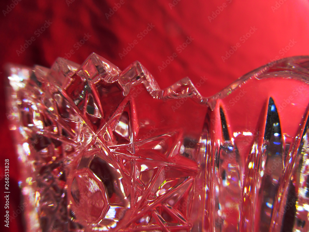 Brilliant glowing crystal glass, red abstract background. Close up ...