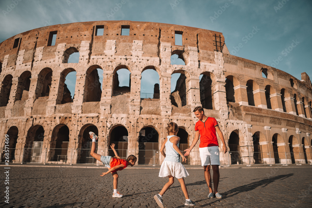 Happy family in Europe. Parents and kids in Rome over Coliseum ...