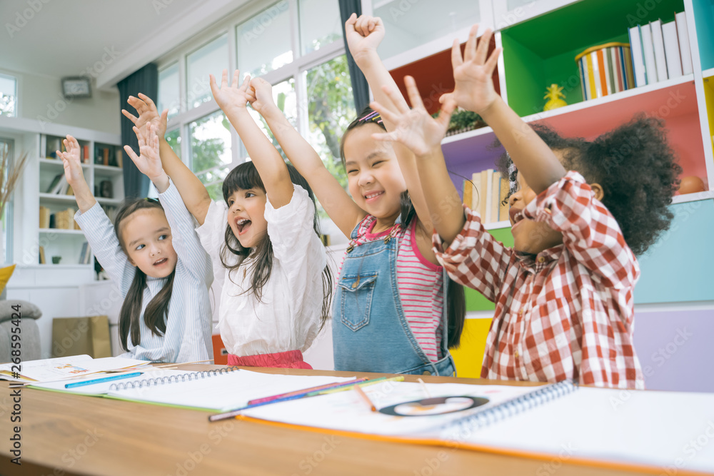 Group of little preschool kids hands up in class . portrait of children ...