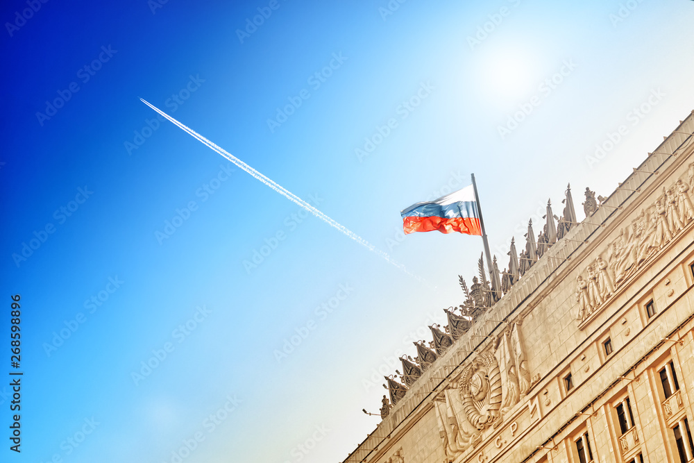 russian flag waving on top of ministry of defense building in moscow ...