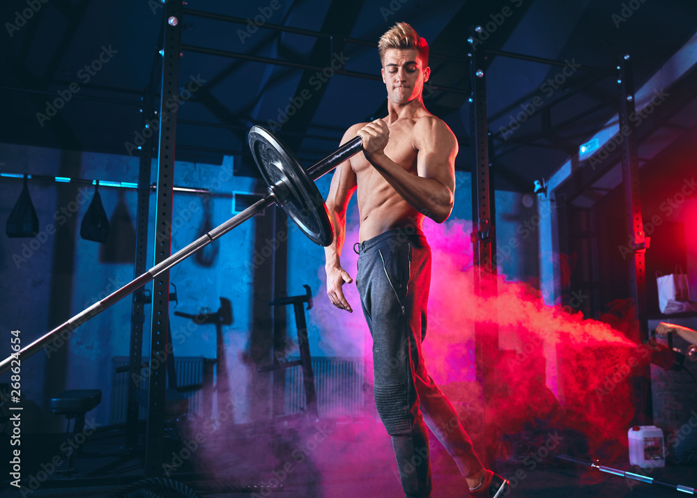 Power athletic male bodybuilder champion doing exercises with heavy ...