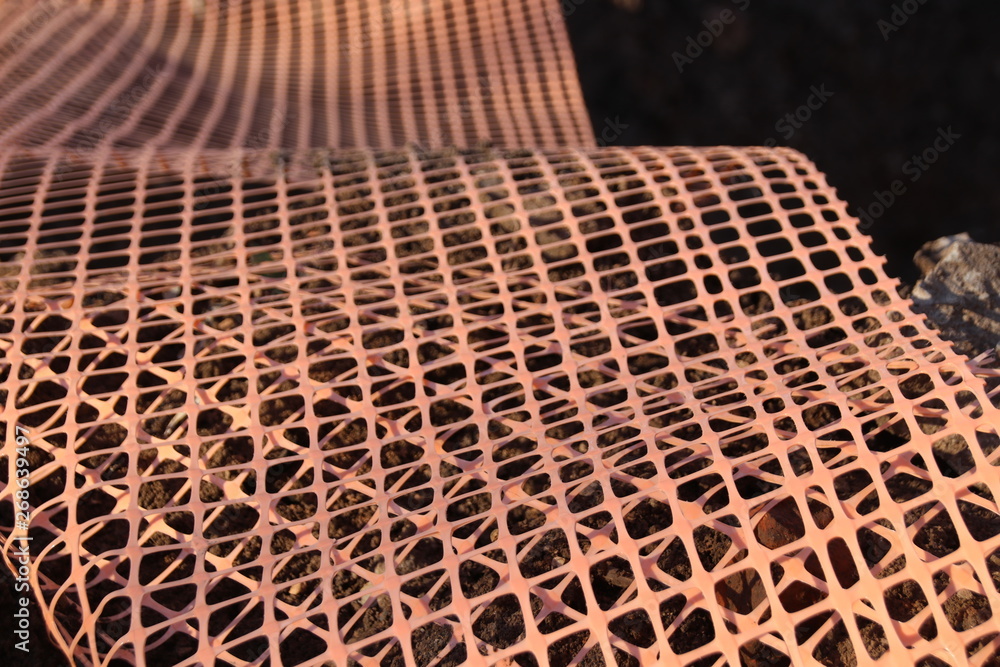 Modern orange safety fence (polymeric mesh grid) closeup Stock Photo ...