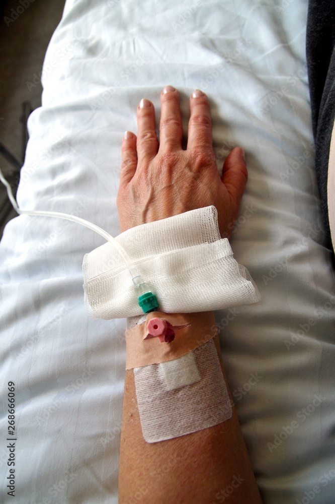 Female patient with infusion drip in hospital. arm of Woman, patient's ...
