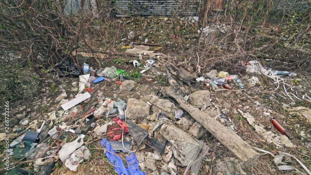 Different garbage lying on the ground in nature. A lot of plastic ...