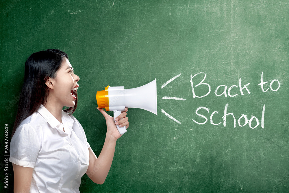 Asian teacher woman using megaphone to notify for go back to school ...
