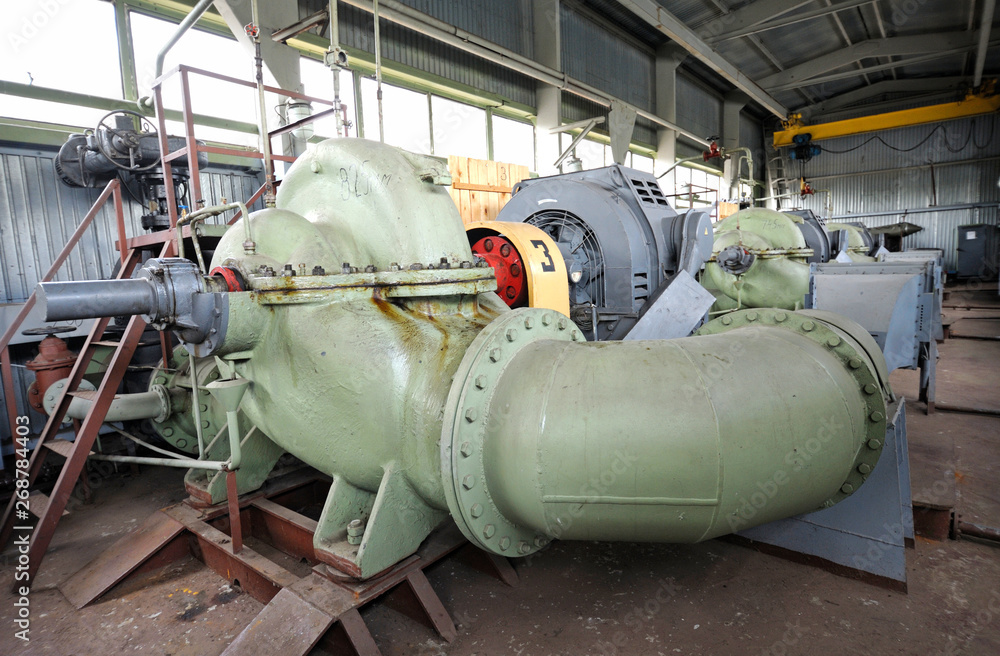 Water pumps and engines set in the hall of the floating pump station ...