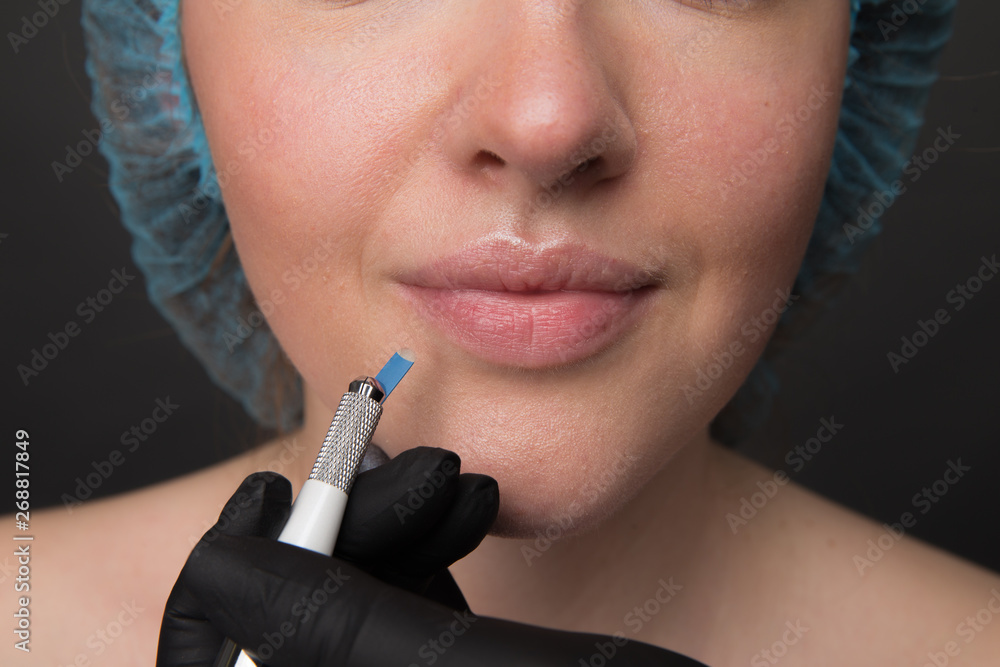 Microblading work flow in a beauty salon. Woman having her eye brows ...