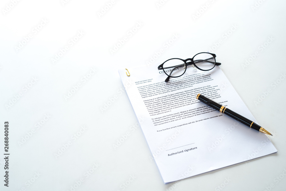 White table with paper contract detail and empty space to sign ...