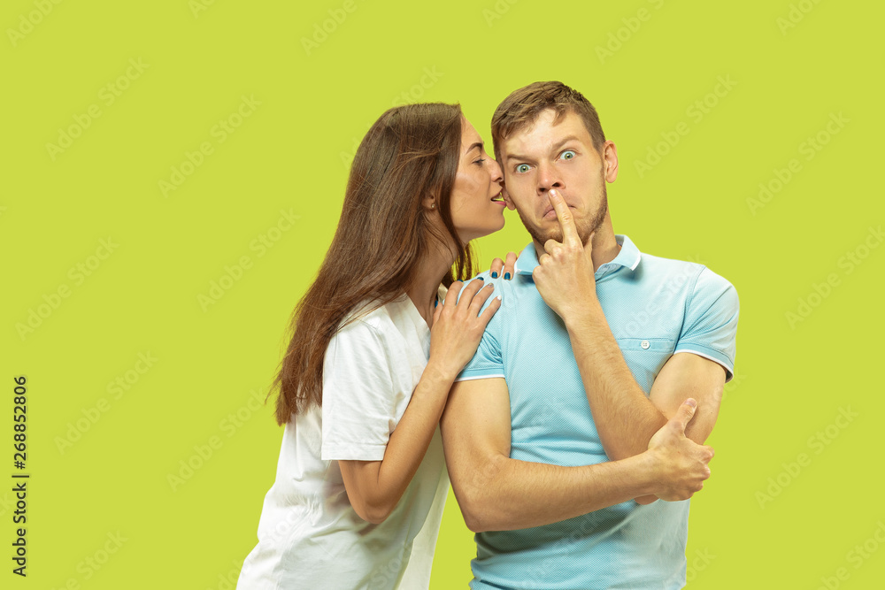 Beautiful young couple's half-length portrait isolated on green studio ...
