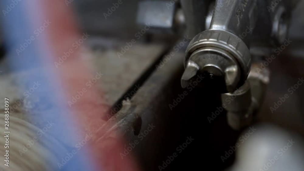 Spray gun for painting in industrial production. Action. Close-up of ...