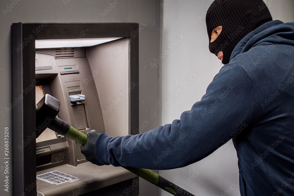Thief. Hacker stealing money from ATM machine. Phishing, ATM skimming ...