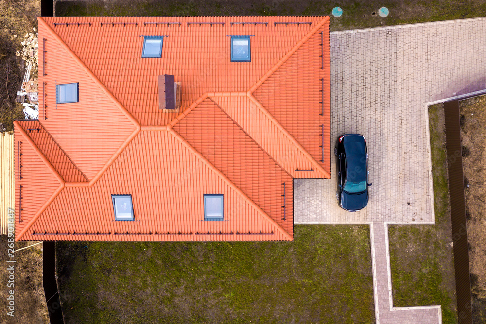 Aerial top view of house metal shingle roof with attic windows and ...